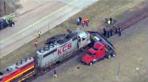 Kansas City Southern Train Hits Semi Truck Stuck on Railroad Tracks in ...